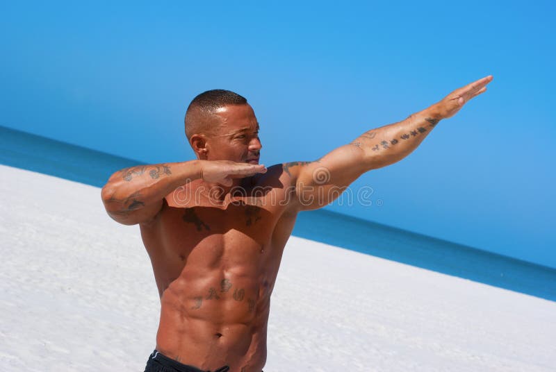 Muscular Man on Beach in a Positive Pose Stock Image - Image of ...