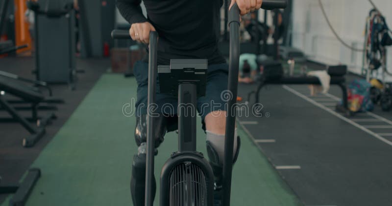 Muscular Man with Bionic Legs Using Spinning Bicycle in Gym Stock ...