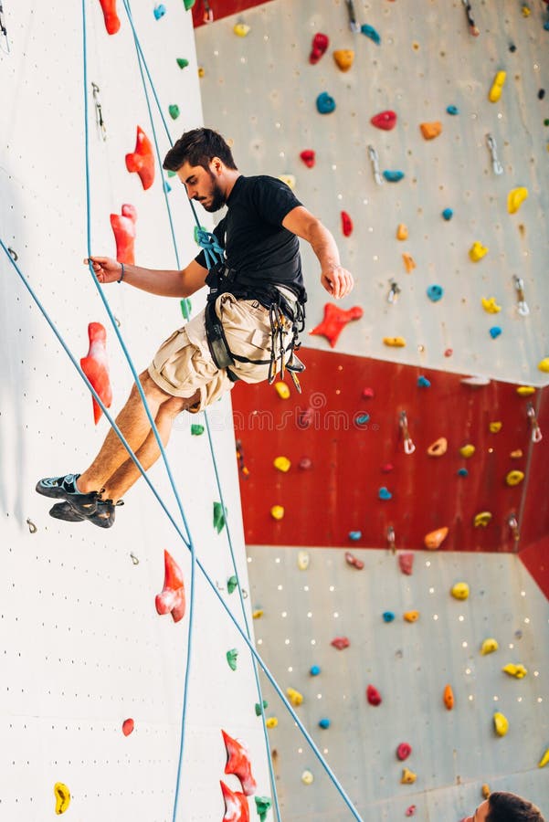 Muscular Man Descending Down on a Big Wall Stock Image - Image of high ...