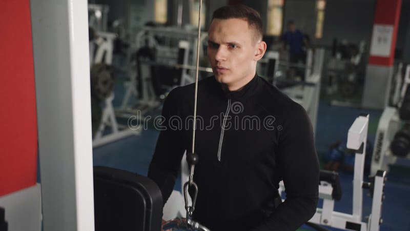 Muscular Man Doing Cable Rope Triceps Push Down Exercise while Working ...