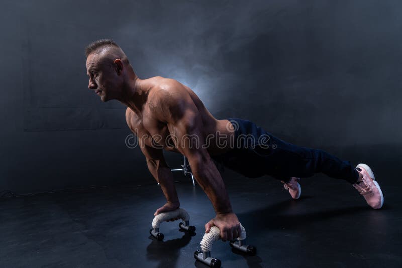 Muscular Man Doing Calisthenic Exercise Isolated on the Black ... Muscular Man Doing Calisthenic Exercise Isolated on the Black ...