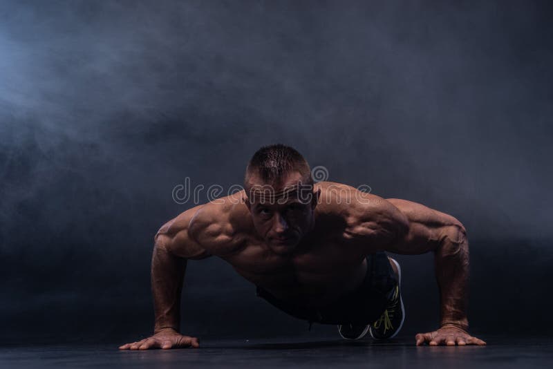 Muscular Man Doing Calisthenic Exercise Isolated on the Black ... Muscular Man Doing Calisthenic Exercise Isolated on the Black ...