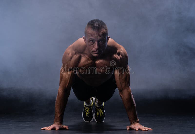 Muscular Man Doing Calisthenic Exercise Isolated On The Black ... Muscular Man Doing Calisthenic Exercise Isolated On The Black ...