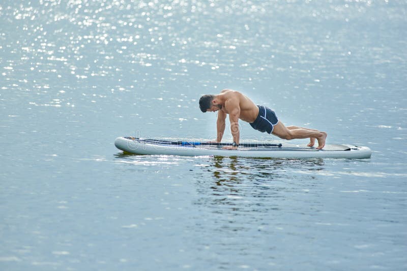 Side View of Fit Man Doing Fitness Exercises Sitting on Sup Board ...