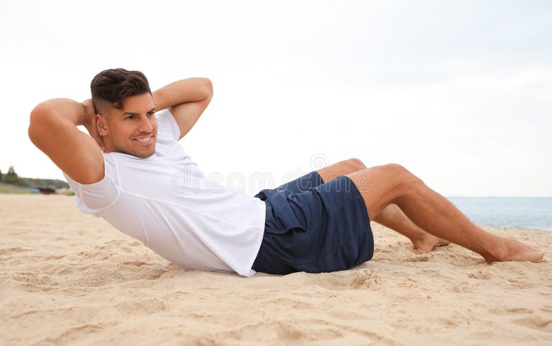 Muscular Man Doing Exercise on Beach. Body Training Stock Image - Image ...
