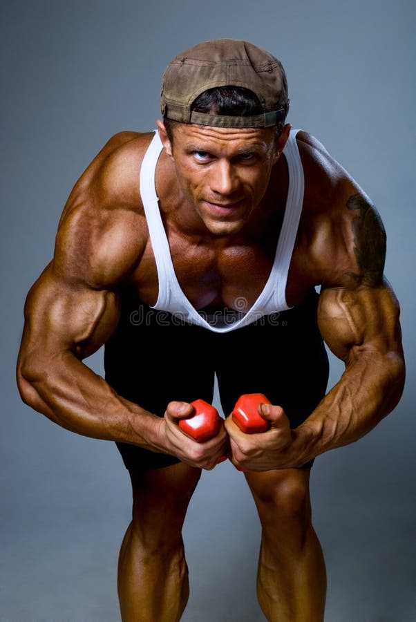 Muscular Man Doing Exercise with Dumbbells. Stock Photo - Image of ...