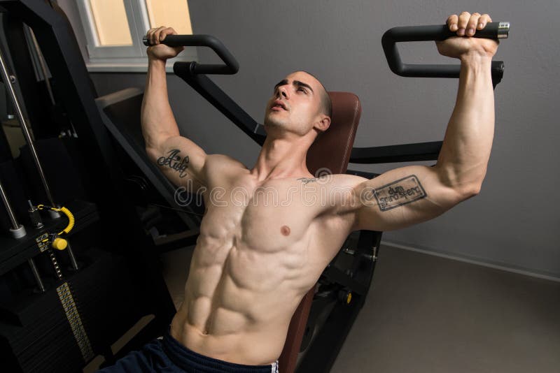 Muscular Man Doing Heavy Weight Exercise for Shoulders Stock Photo ...