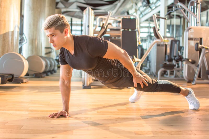 Muscular Man Doing Push-ups on One Hand in the Gym. Stock Image - Image ...