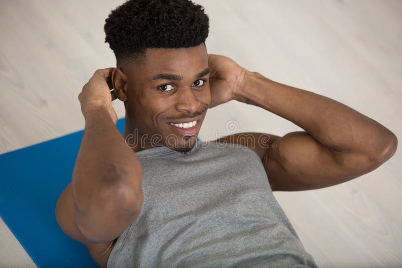 Muscular man doing sit-ups stock photo. Image of lifestyle - 261950430