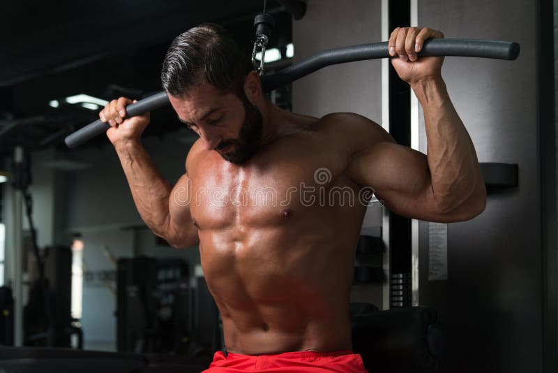 Muscular Man Exercising Back on Cable Machine Stock Image - Image of ...