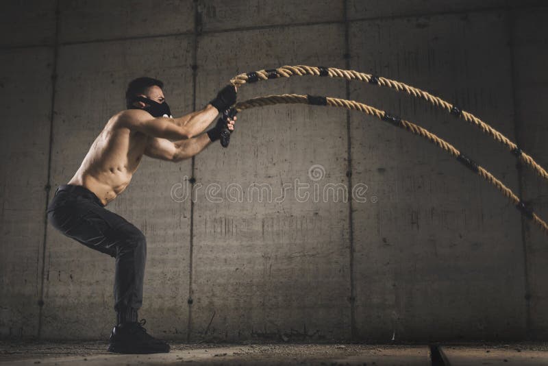 Muscular Man Exercising with Battle Ropes Stock Image - Image of ...