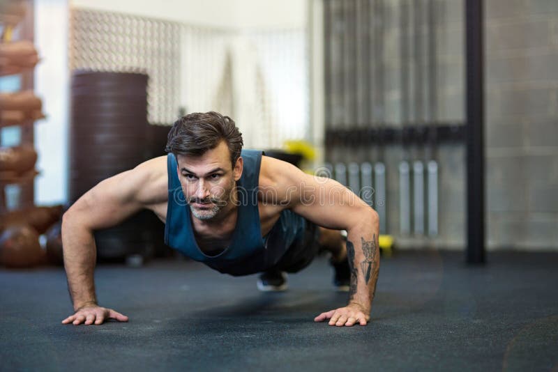 Man working out in gym stock photo. Image of athlete - 111720730