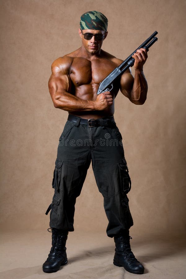 A Muscular Man with a Gun in Full View. Stock Photo - Image of beauty ...