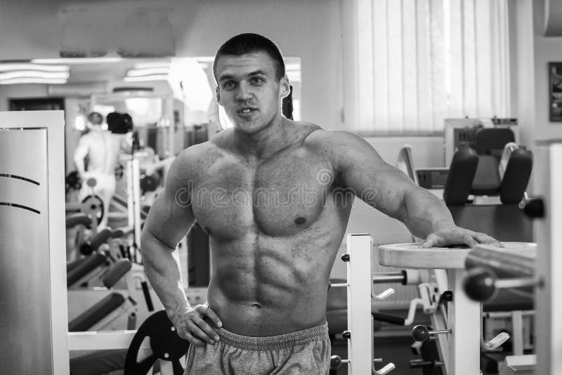 Muscular Man in the Gym Performing the Exercise Stock Photo - Image of ...