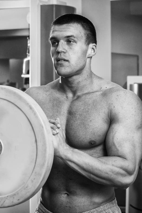 Muscular Man in the Gym Performing the Exercise Stock Image - Image of ...