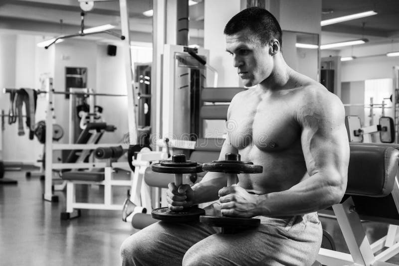 Muscular Man in the Gym Performing the Exercise Stock Photo - Image of ...
