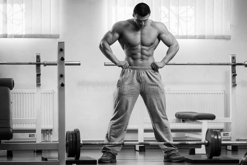 Muscular Man in the Gym Performing the Exercise Stock Image - Image of ...