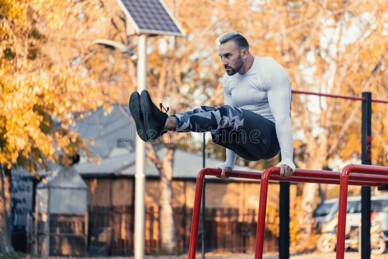 Muscular Man Hitting the Frontal Abs on Parallel Bars Outside Workout ...