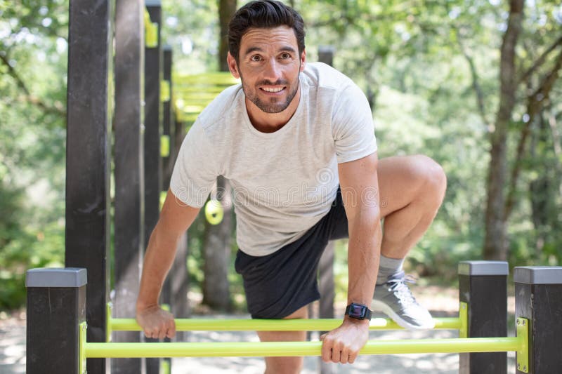 Muscular Man Jumping Pull-ups on Horizontal Bar in Park Stock Image ...