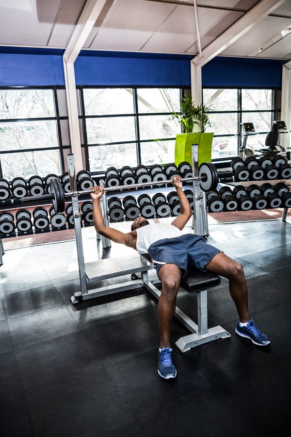 Muscular Man Lifting Barebell while Lying on Bench Stock Photo - Image ...
