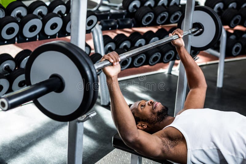 Muscular Man Lifting Barebell while Lying on Bench Stock Image - Image ...