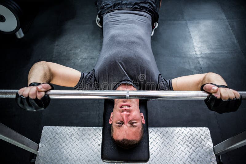Muscular Man Lifting Barebell while Lying on Bench Stock Image - Image ...