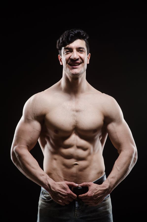 Muscular Man Posing in Dark Studio Stock Photo - Image of macho ...