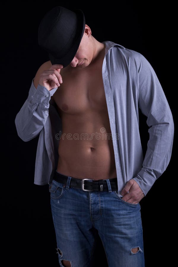 A Muscular Man Posing with Hat,on Black Background Stock Image - Image ...