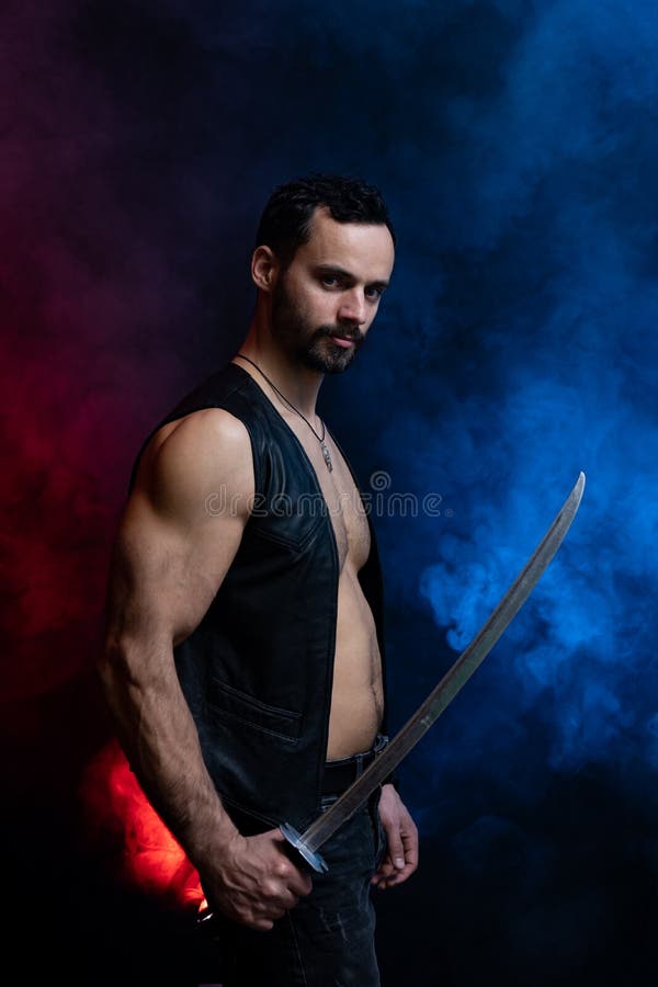Muscular Man Posing with Long Sword Isolated on Black and Smoked ...