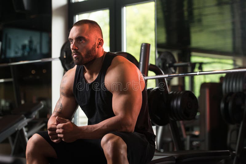 Muscular Man Resting on the Bench Stock Photo - Image of biceps ...