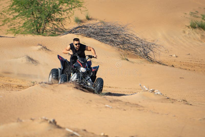 Muscular Man Riding Atv in the Desert Stock Image - Image of sand ...