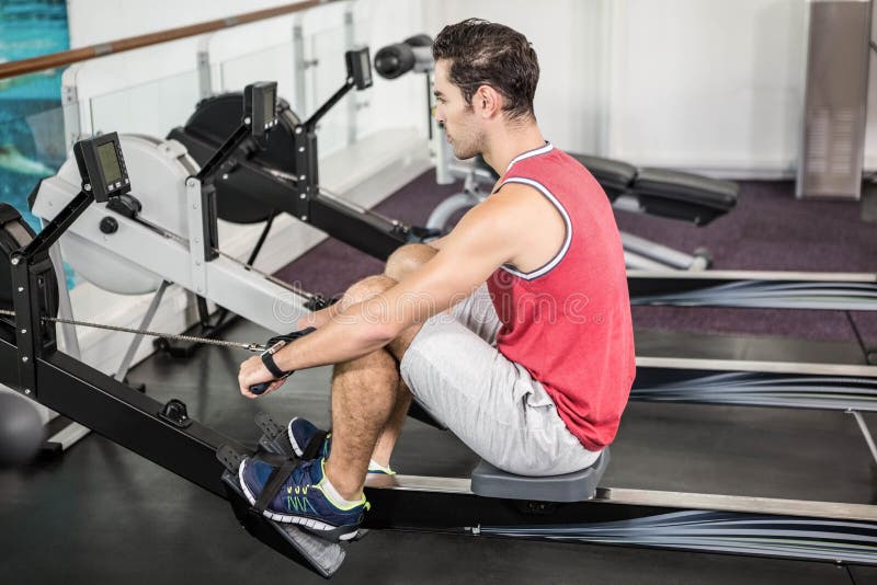 Muscular Man on Rowing Machine Stock Image - Image of strength ...
