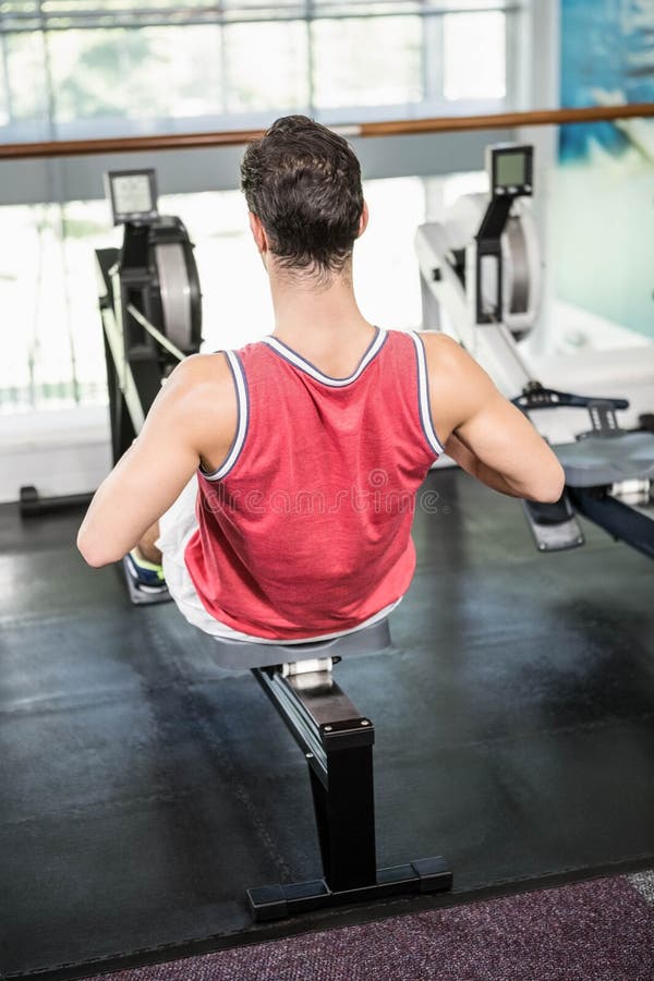 Muscular Man on Rowing Machine Stock Image - Image of studio, lifestyle ...