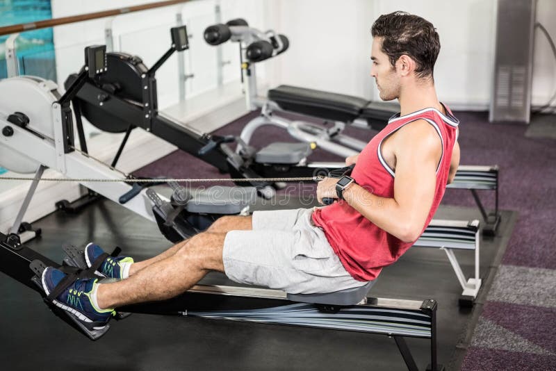 Muscular Man on Rowing Machine Stock Photo - Image of slim, club: 66431874