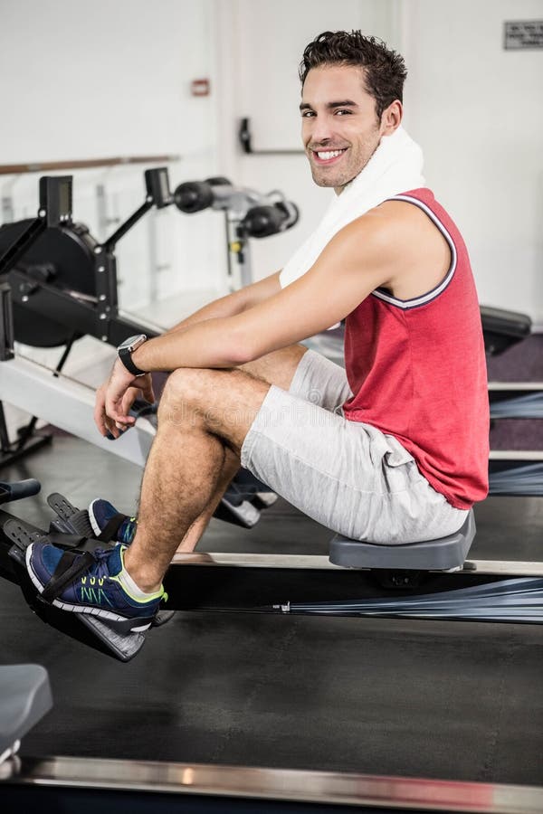 Muscular Man on Rowing Machine Smiling at the Camera Stock Photo ...