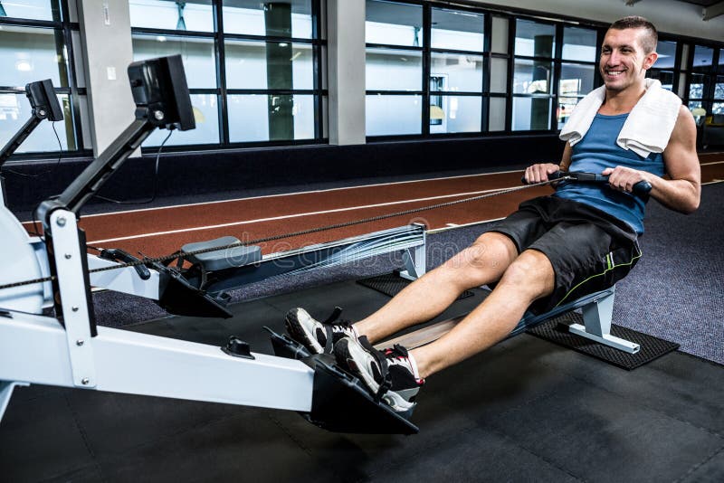 Muscular Man Using Rowing Machine Stock Image - Image of recreation ...