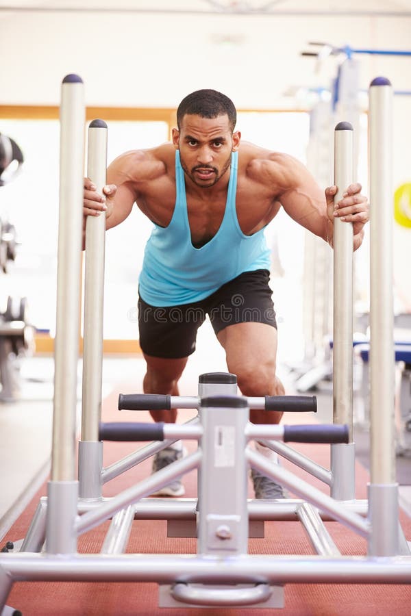 Muscular Man Working Out Using Equipment at a Gym, Vertical Stock Image ...