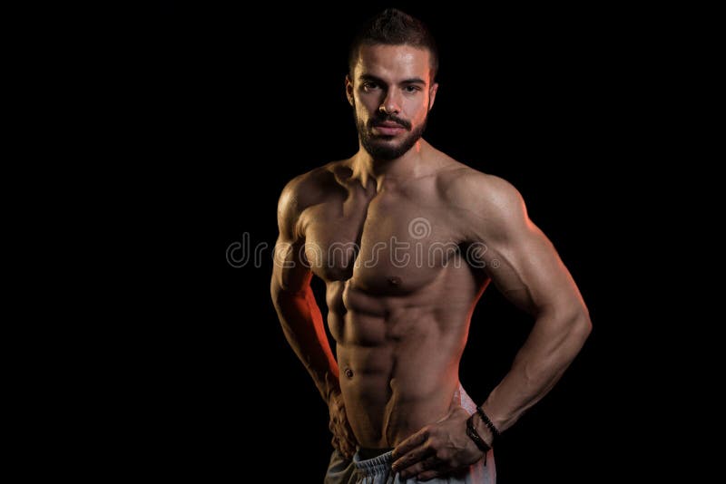 Muscular Model Flexing Muscles on Black Background Stock Image - Image ...