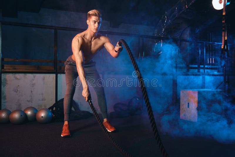 Muscular Powerful Man Training with Rope in Functional Training Gym ...