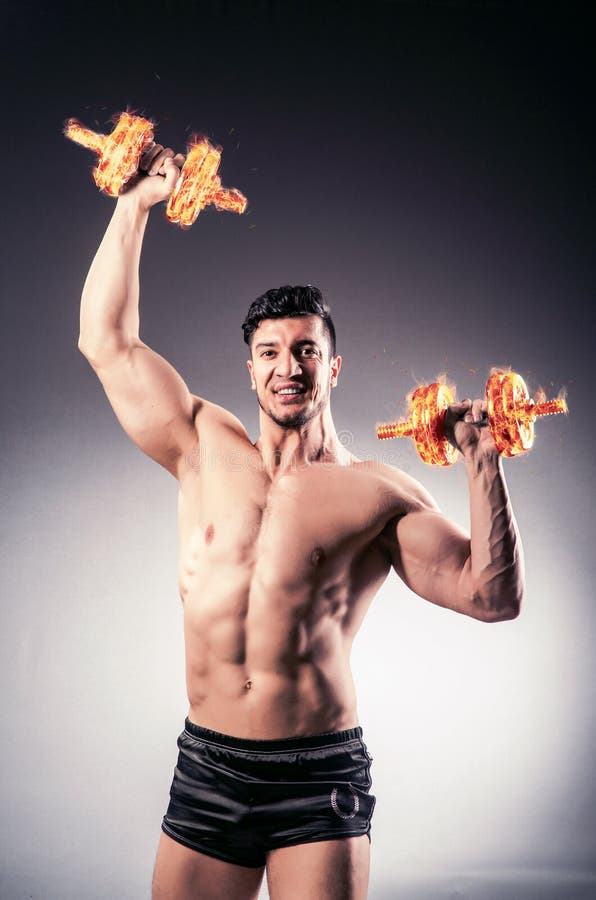 The Muscular Ripped Bodybuilder with Burning Dumbbells Stock Image ...