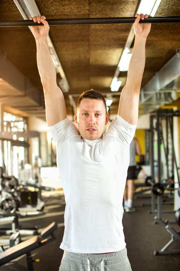 Muscular Strong Man Working Out at a Gym. Stock Image - Image of ...