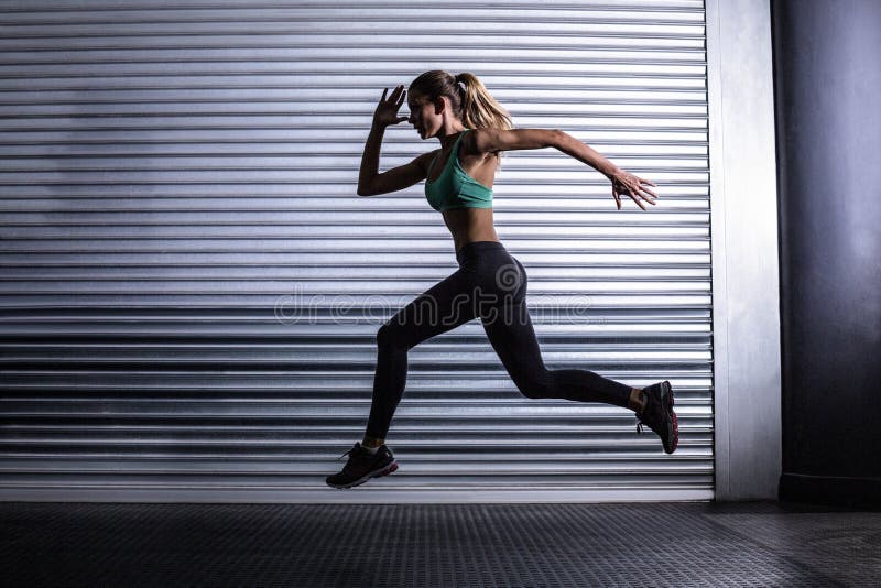 Muscular Woman Running in Exercise Room Stock Photo - Image of leisure ...