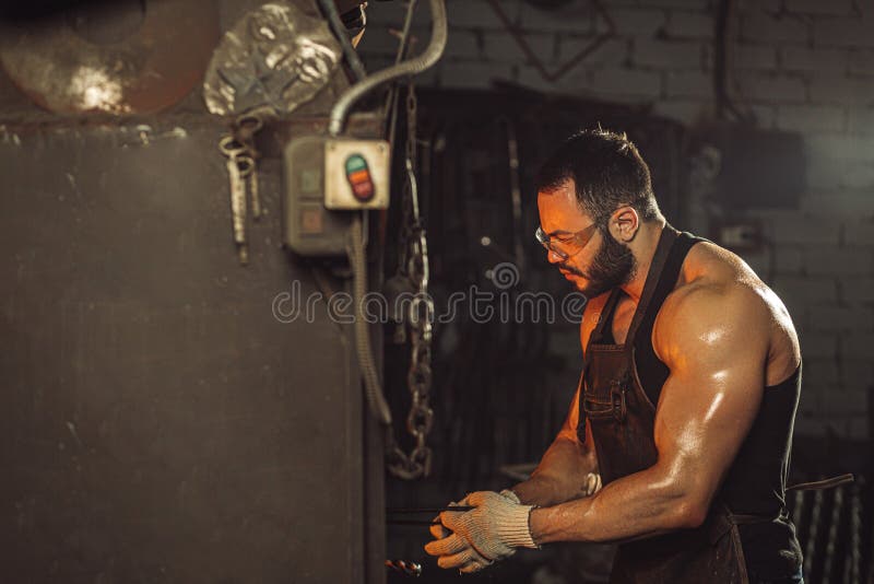 Muscular Young Blacksmith in Leather Uniform Stock Photo - Image of ...