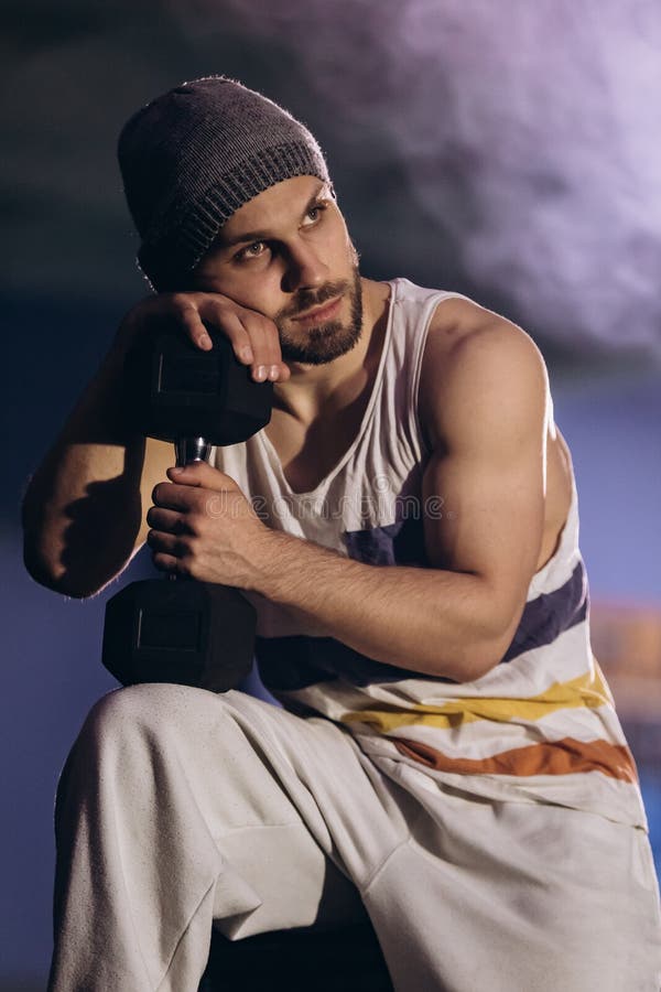 Muscular Bodybuilder with Dumbbells in Smoke Stock Image - Image of ...