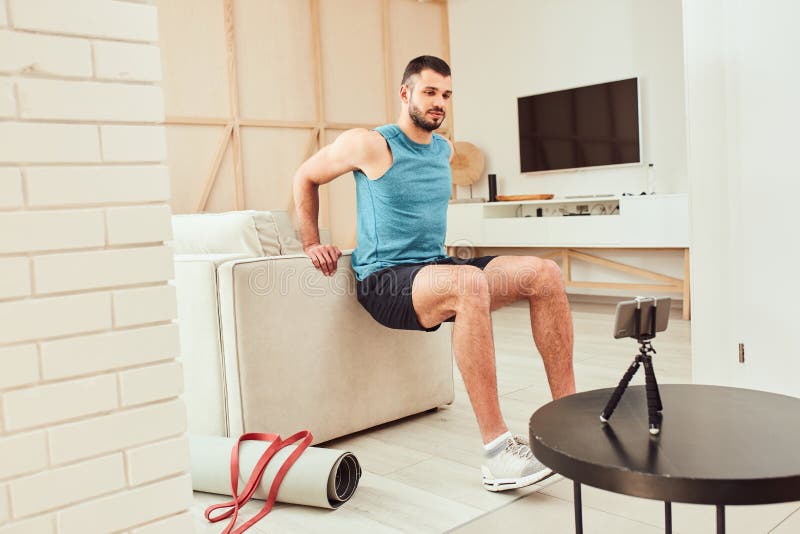 Muscular Young Man Using Couch during Home Workout Stock Image - Image ...