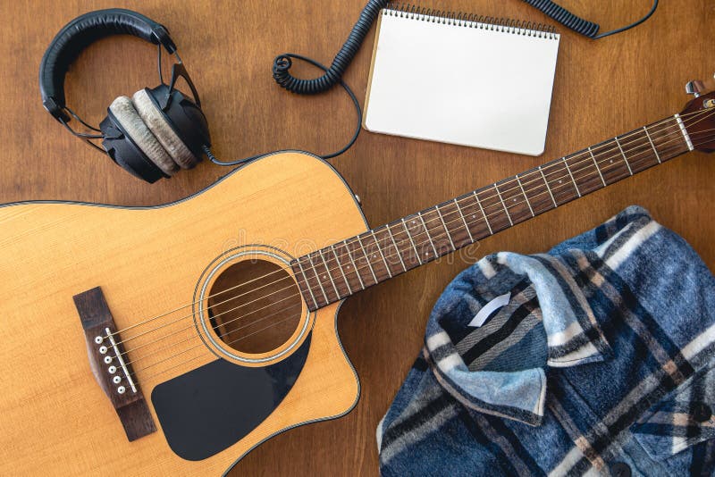 Music Background with Guitar, Headphones and Notepad, Top View. Stock ...