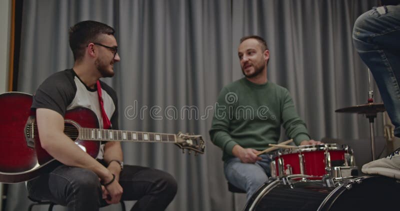Music Band Practicing in a Studio, Playing Guitar, Drums, and Keyboard ...