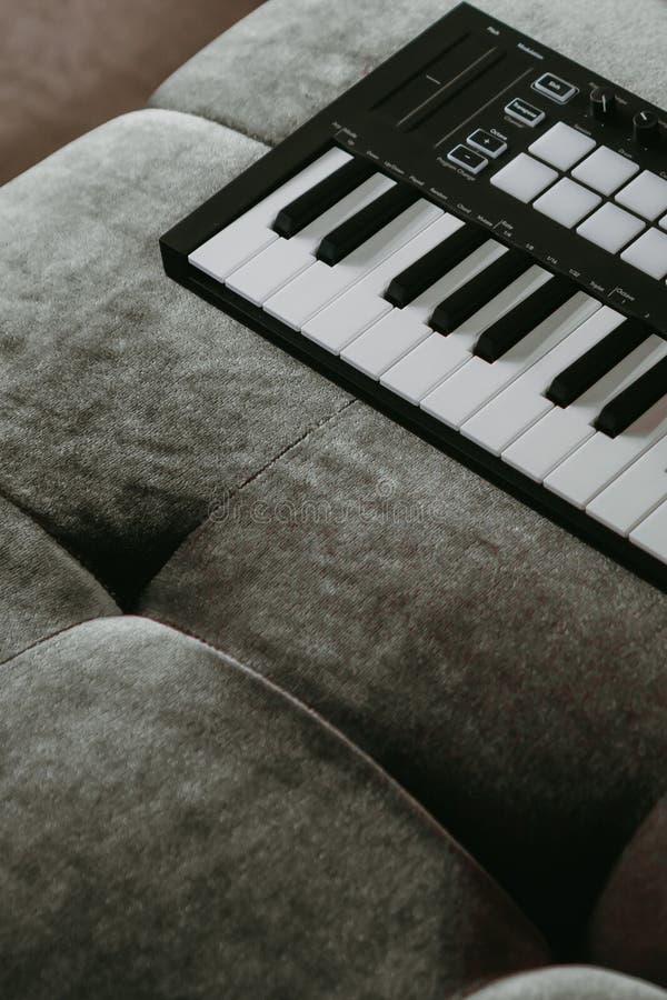 Music Keyboard Placed on a Cozy Couch in a Living Room Stock Photo ...