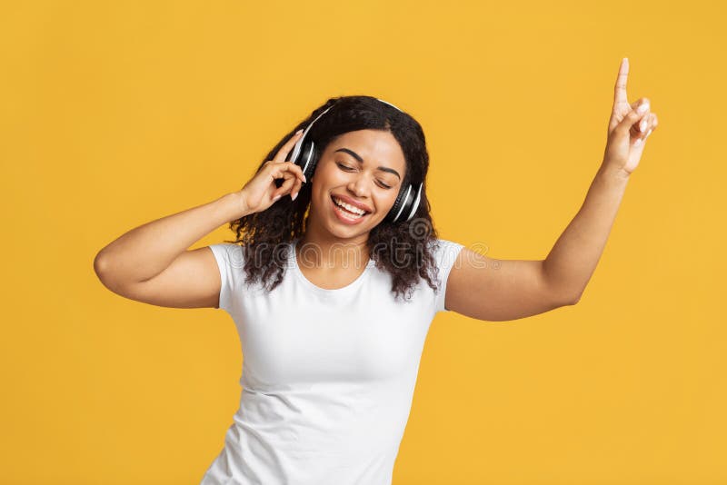 Music Lover Carefree Black Woman Listening Music In Headphones And