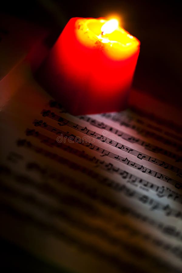 Music Notes Sheet in a Red Candle Light Stock Image - Image of ...